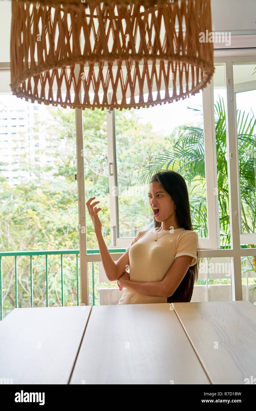 Beautiful woman posing - sitting, angry and stressed Stock Photo - Alamy