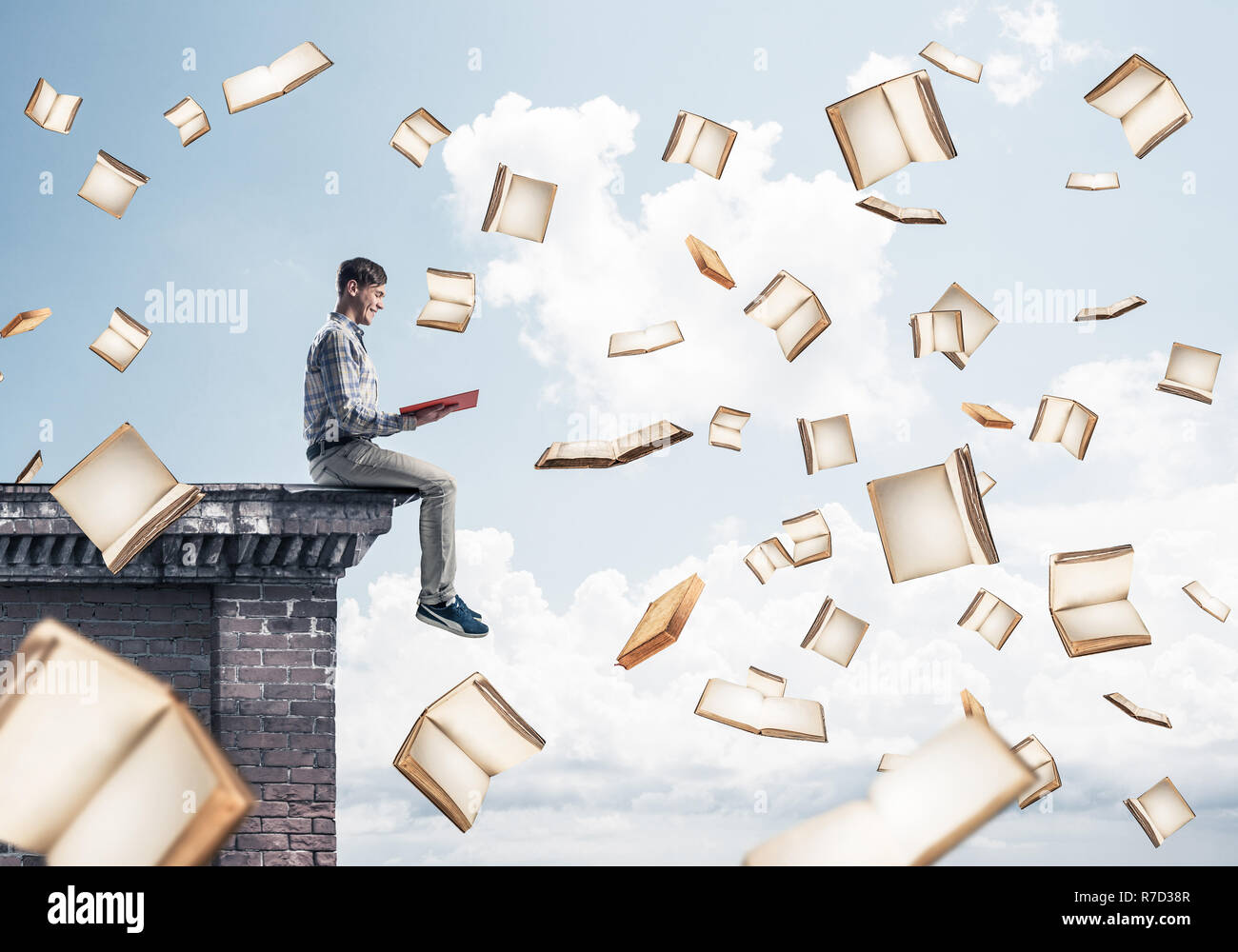 Man reading book and many of them flying in air Stock Photo - Alamy