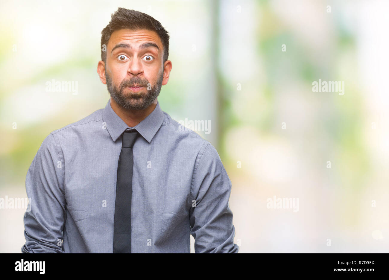 Adult hispanic business man over isolated background puffing cheeks ...