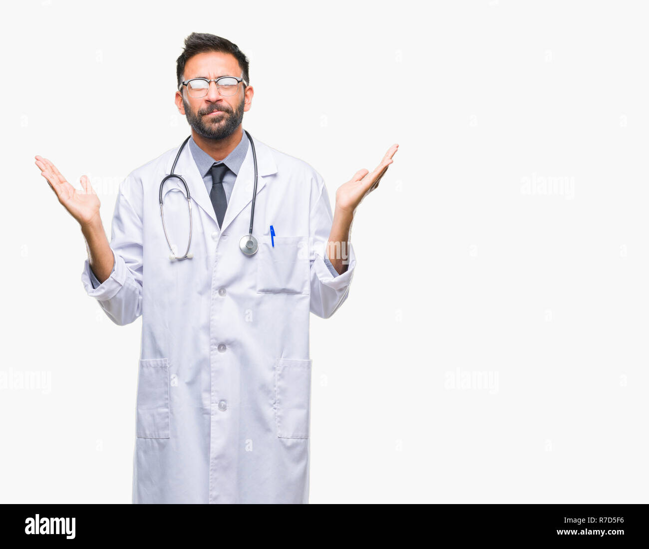 Adult hispanic doctor man over isolated background clueless and ...