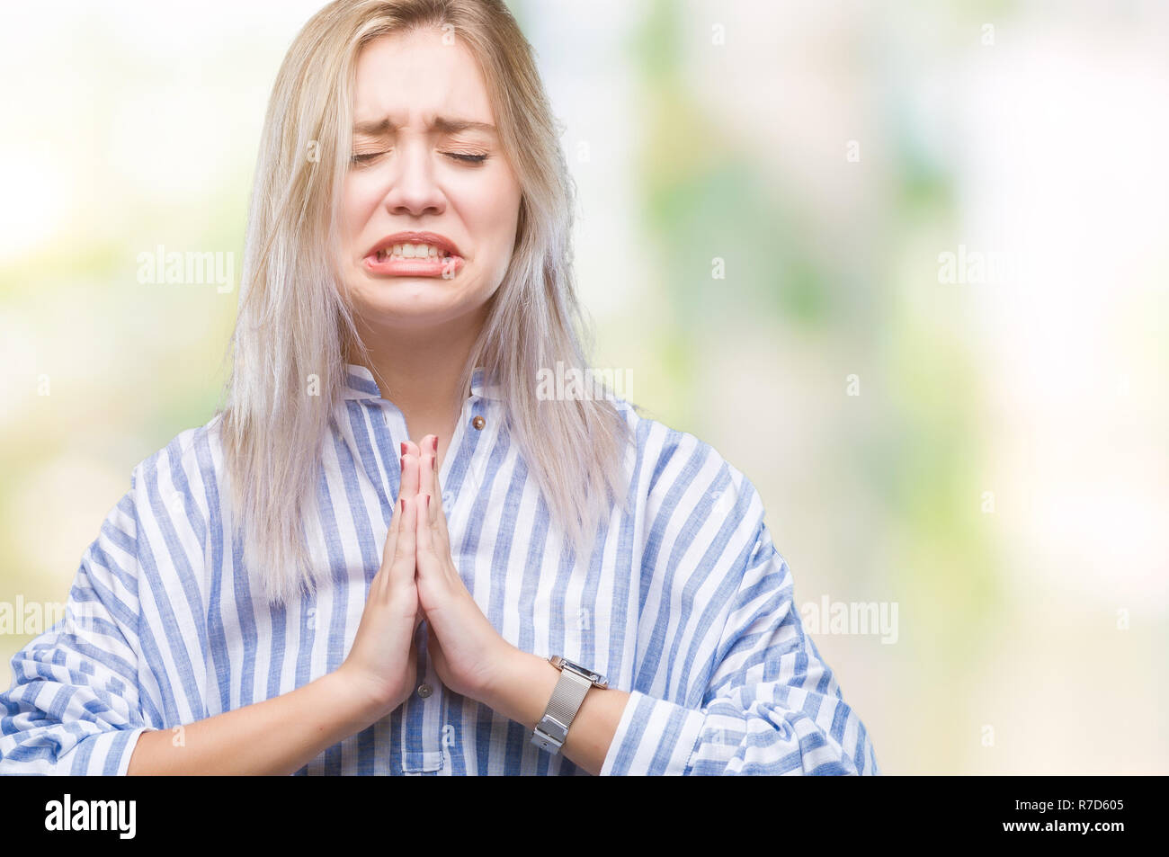 Young blonde woman over isolated background begging and praying with ...