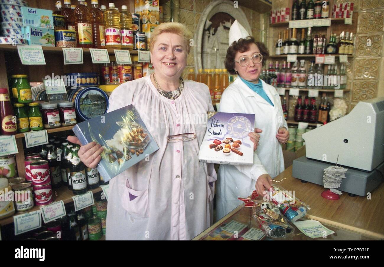 women in store behind counter taking photo Stock Photo - Alamy