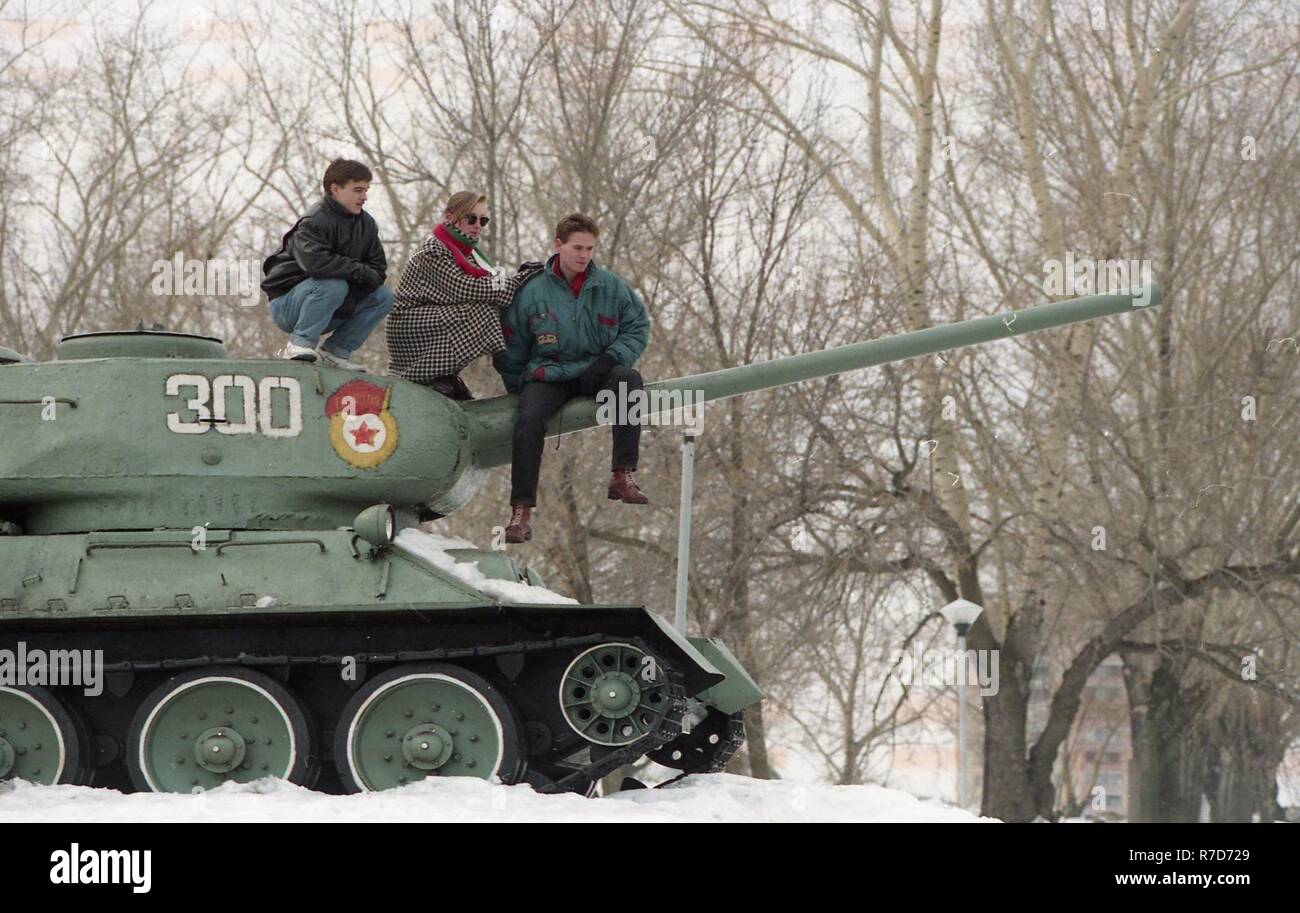 Men sitting on a tank Stock Photo - Alamy