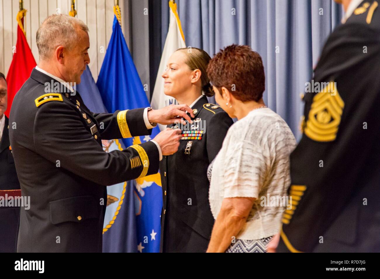 Maj. Gen. Thomas E. Ayres, Deputy Judge Advocate General, awards the ...