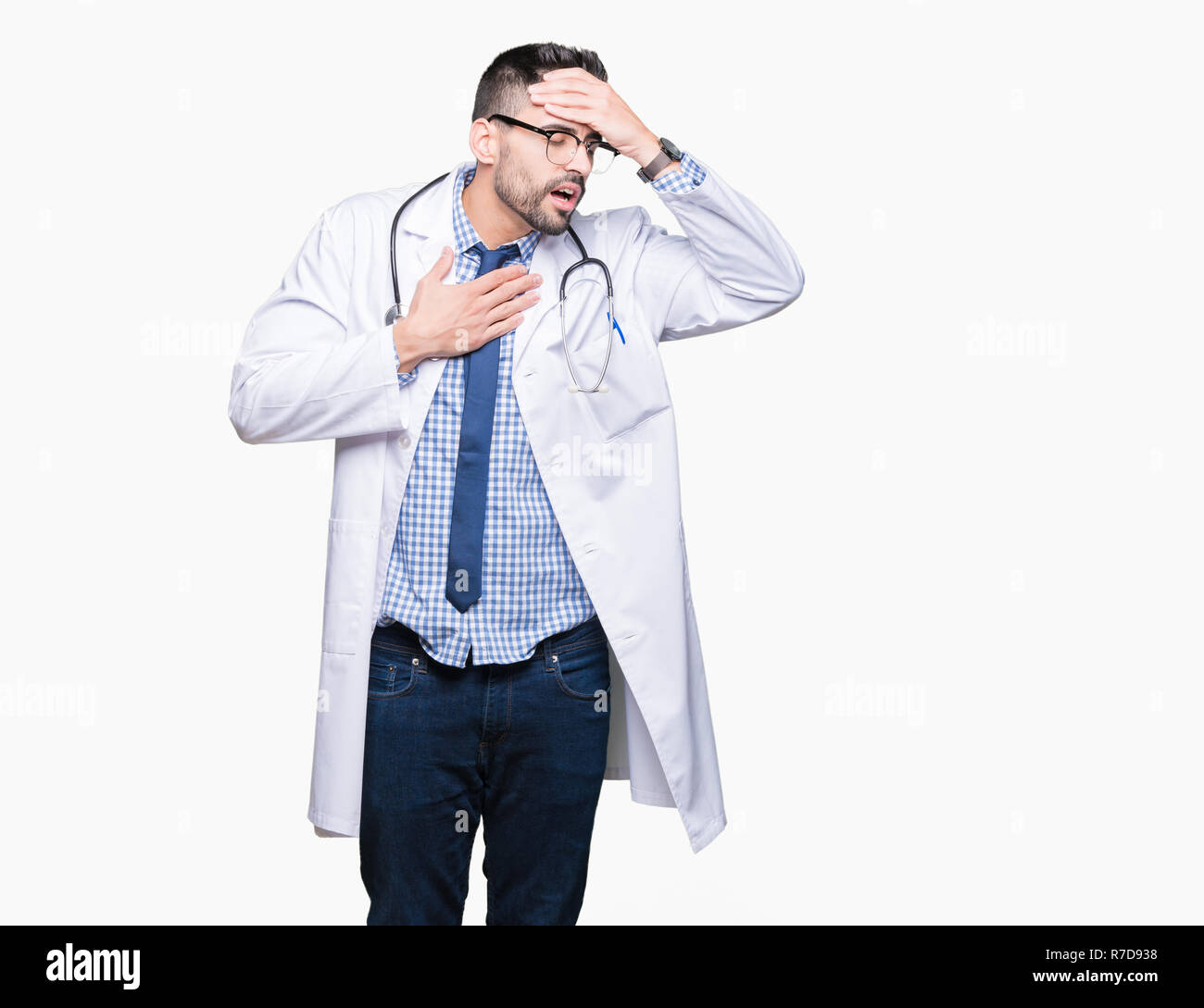 Handsome young doctor man over isolated background Touching forehead ...