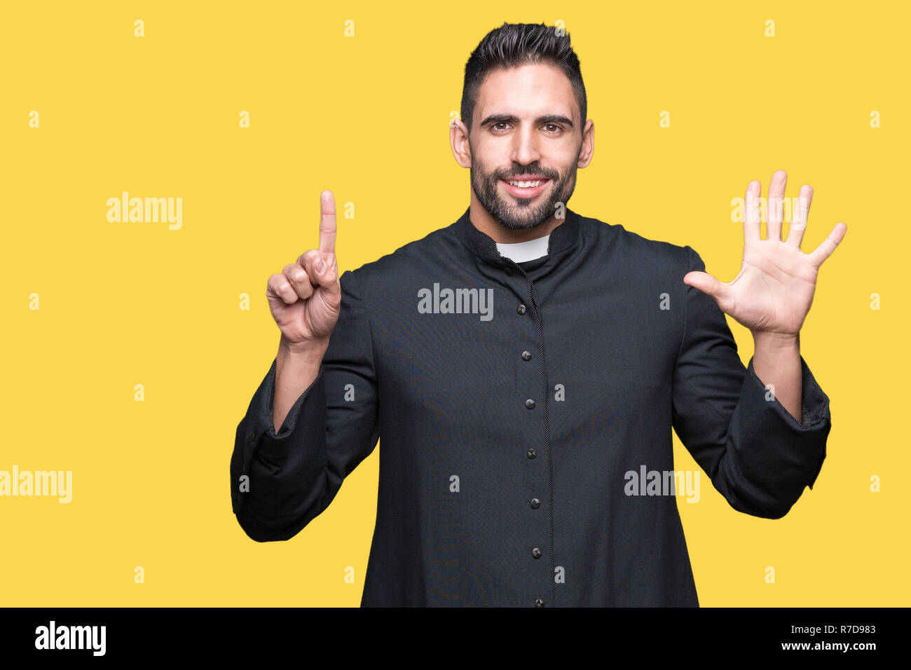 Young Christian priest over isolated background showing and pointing up ...