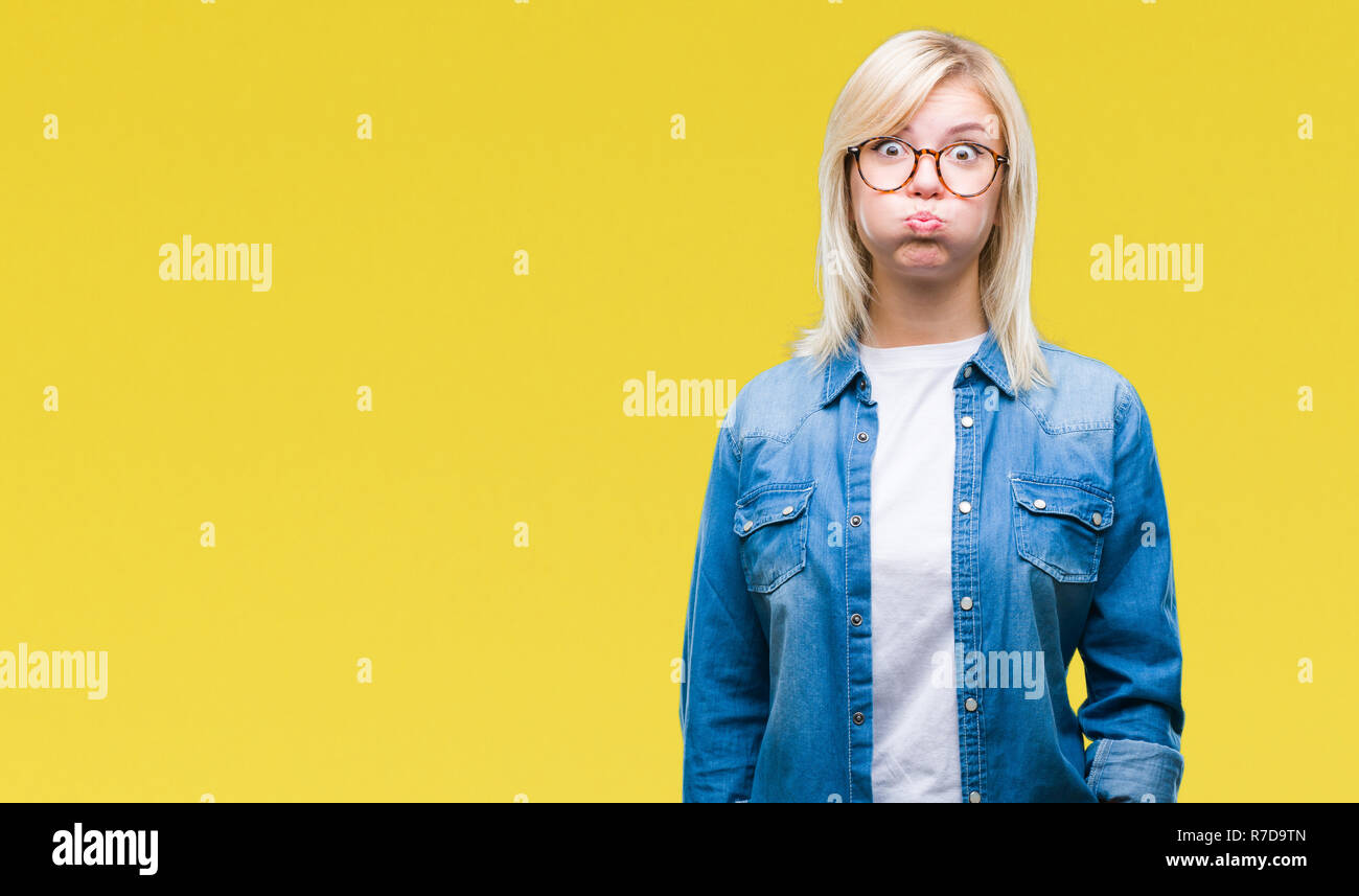 Young beautiful blonde woman wearing glasses over isolated background ...