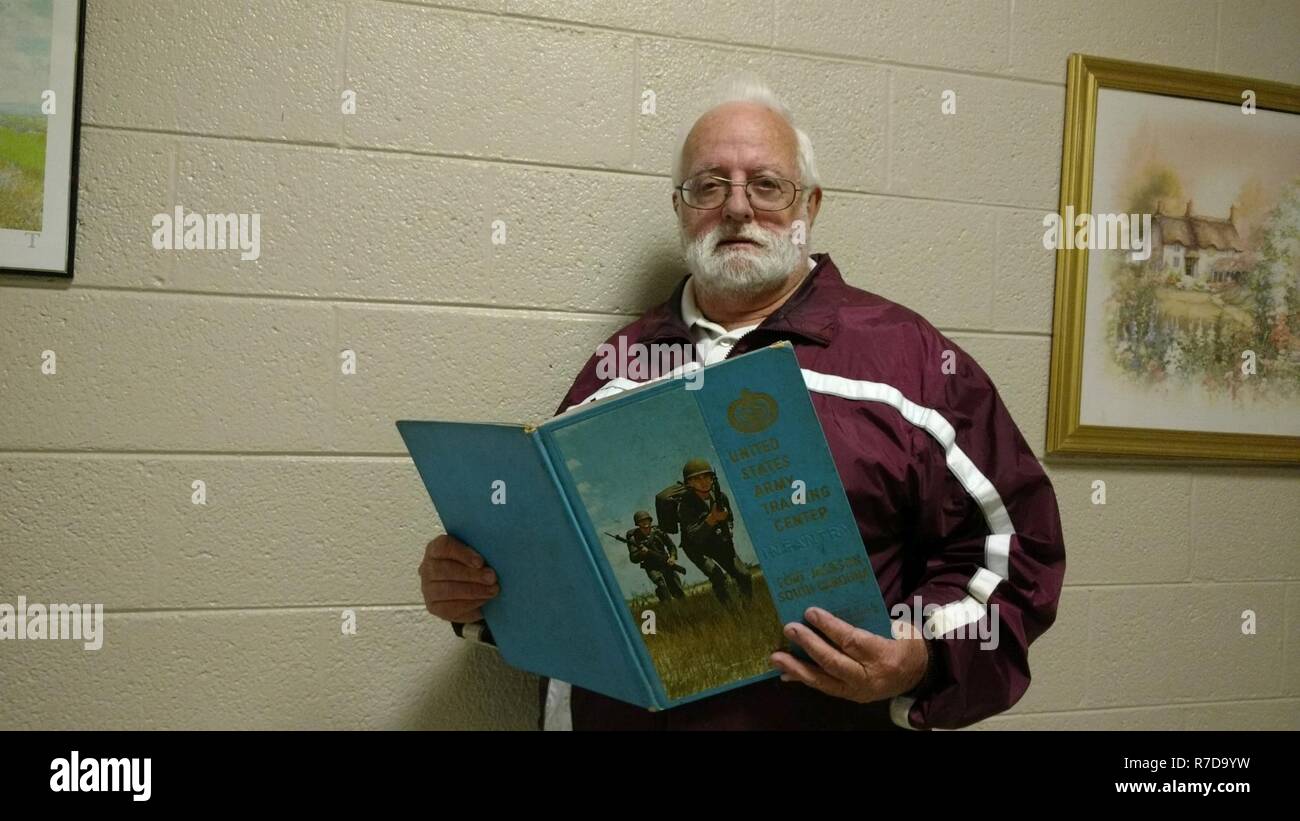 William Whitten, a former Fort Jackson Soldier, holds the yearbook from ...