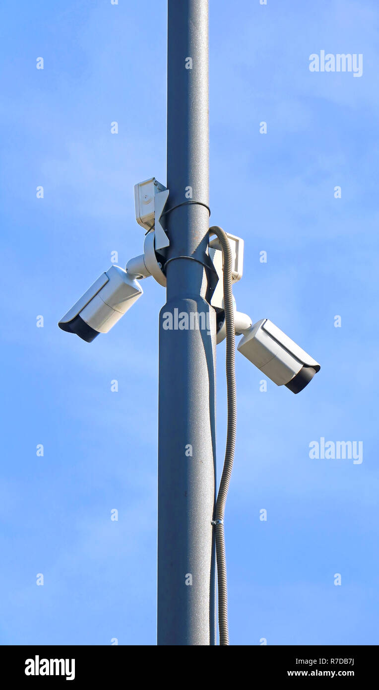 Cameras hanging from tole pole on street used for CCTV monitoring Stock ...