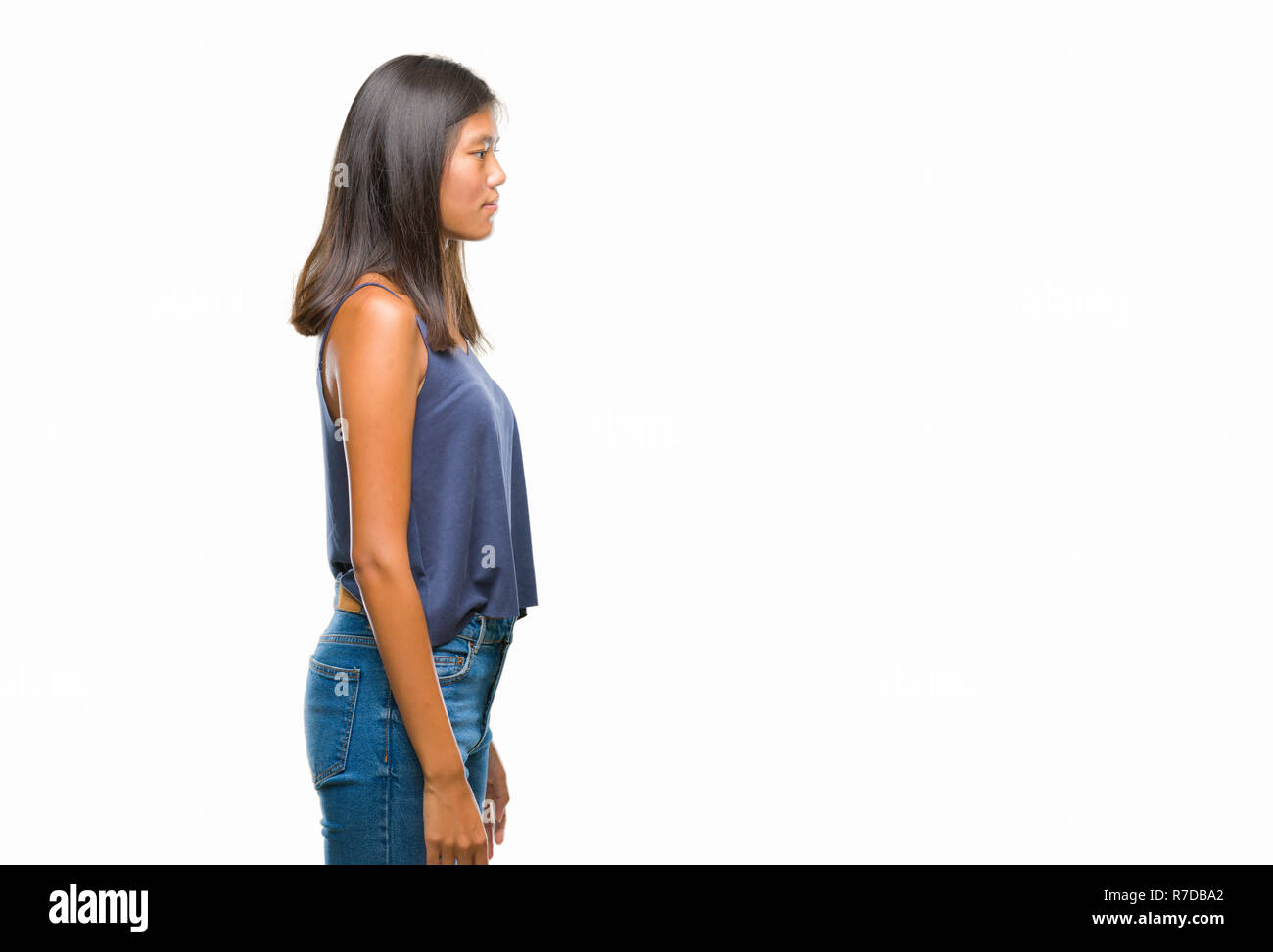 Young asian woman over isolated background looking to side, relax ...