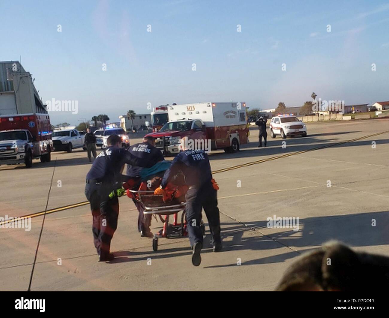 An Air Station Corpus Christi MH-65 Dolphin helicopter crew transfers a ...