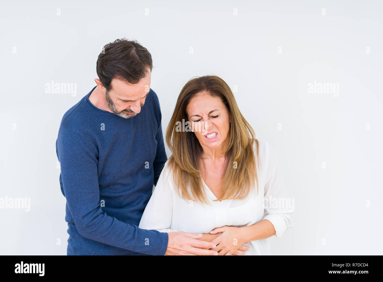 Beautiful middle age couple in love over isolated background with hand ...