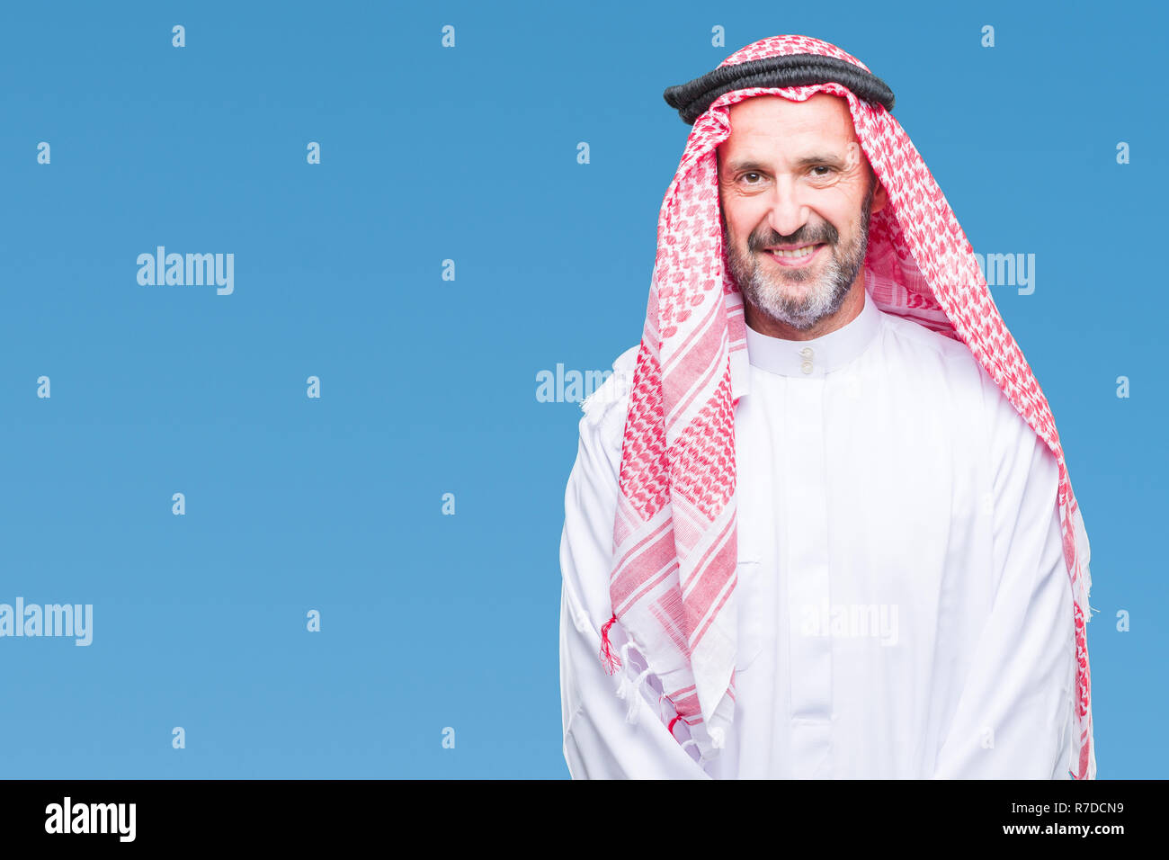 Senior arab man wearing keffiyeh over isolated background with a happy ...