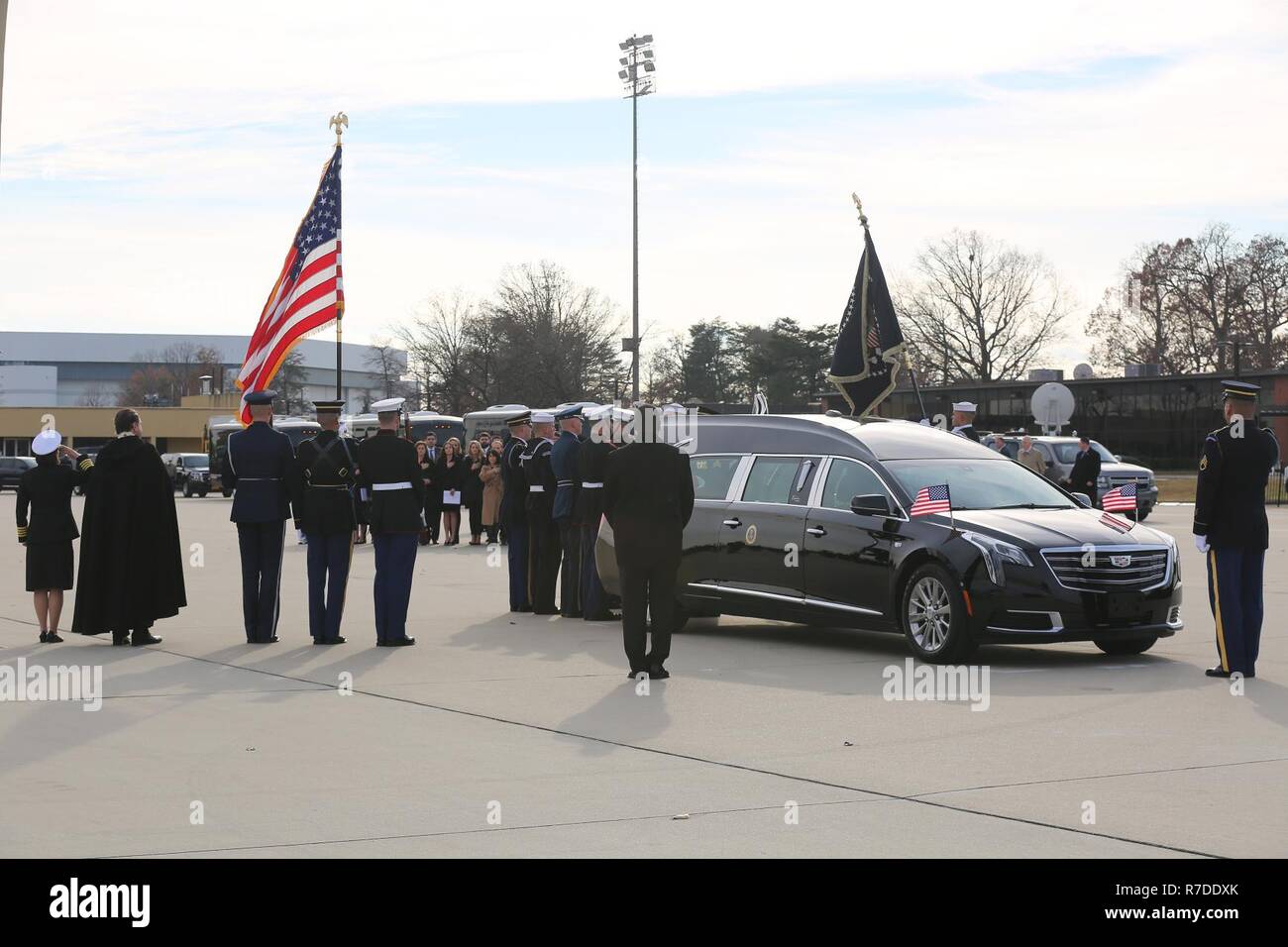 U.S. service members with the Ceremonial Honor Guard retrieve the casket from the hearse ...