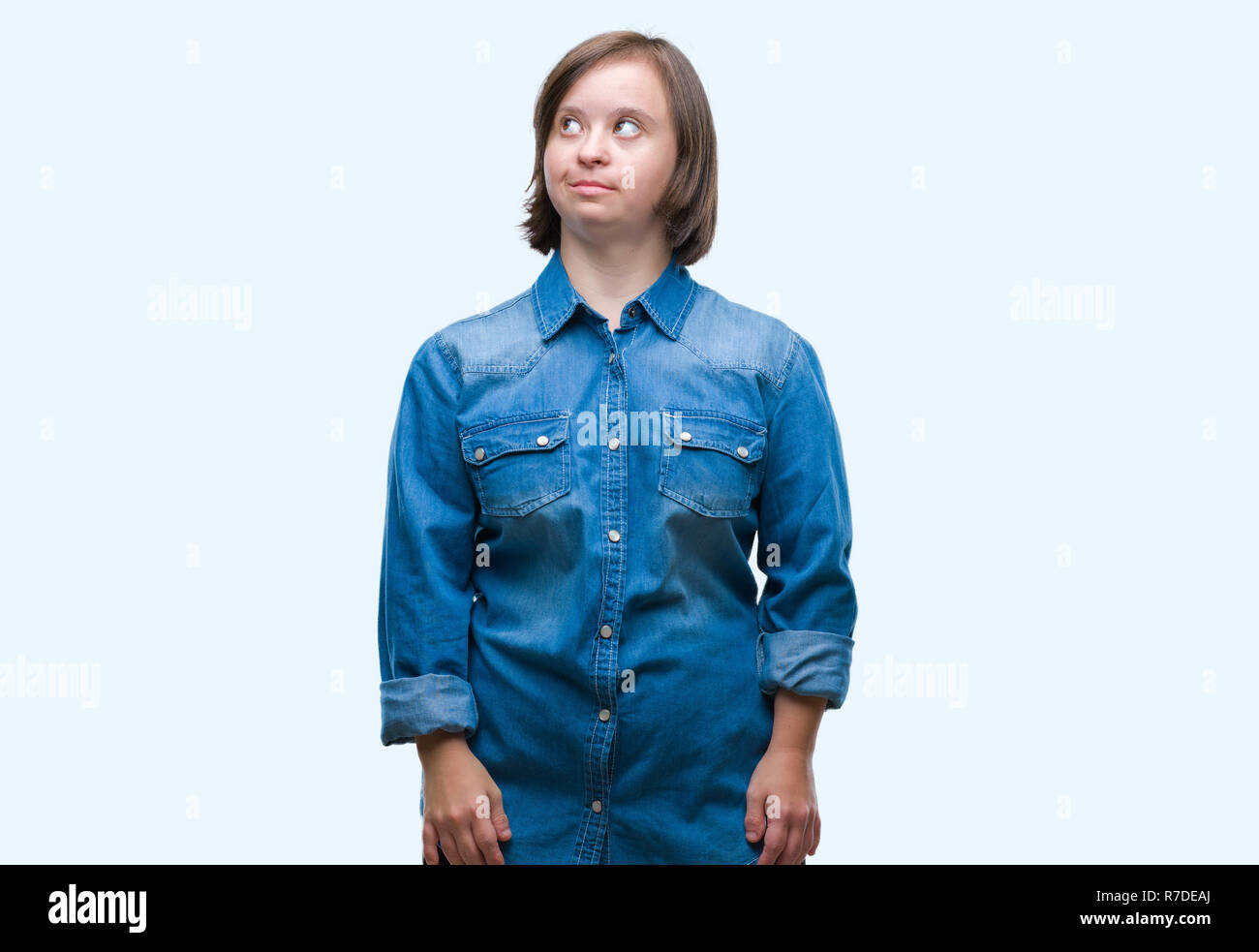 Young adult woman with down syndrome over isolated background smiling ...