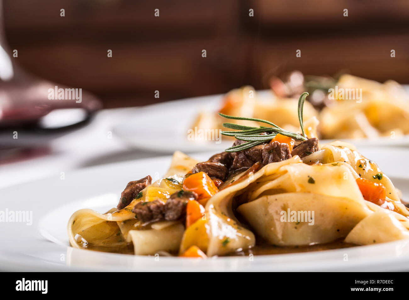 Idalian pasta pappardelle with beef ragout on white plate Stock Photo ...