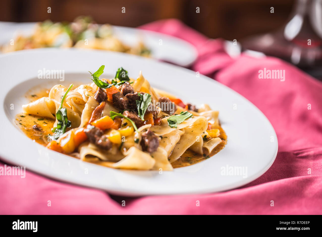 Idalian pasta pappardelle with beef ragout on white plate Stock Photo ...