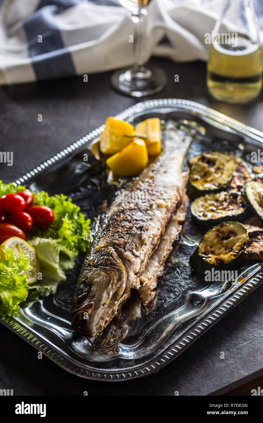 Roasted fish on dish with fresh and grilled vegetable Stock Photo - Alamy