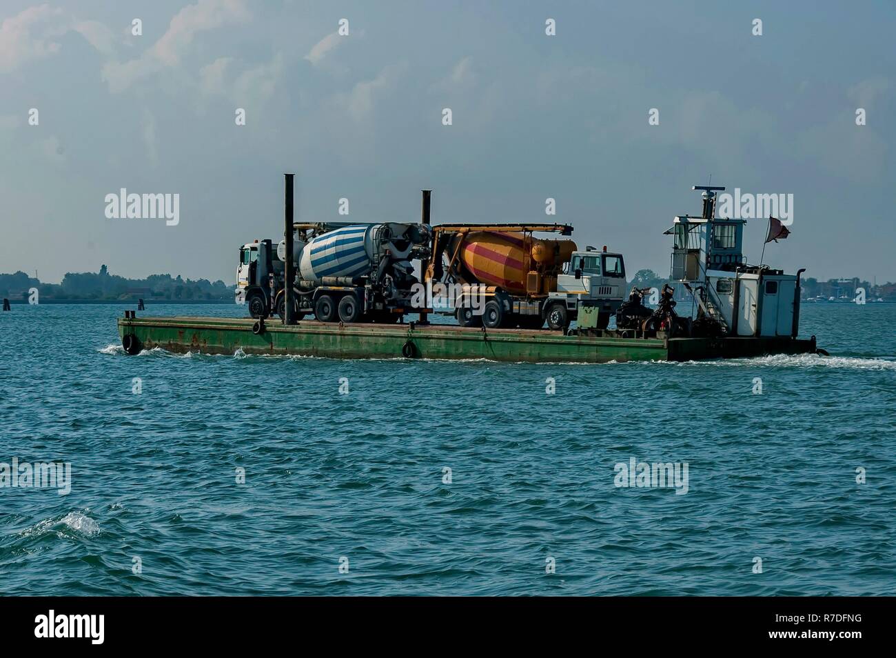 One load flat-boat ferry two concrete mixer truck via the lagoon, Italy ...
