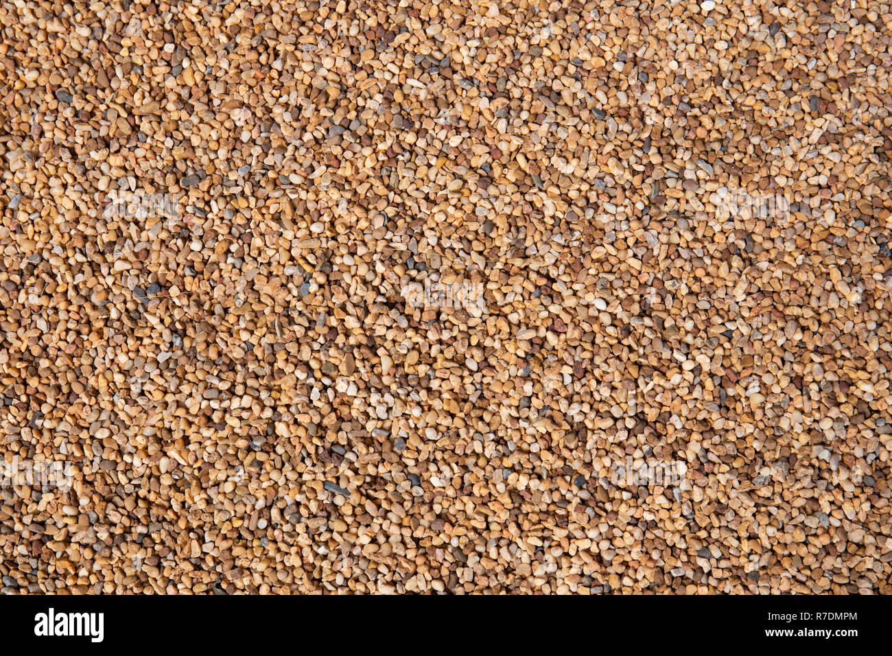 Surface sand grains and small stones backdrop Stock Photo - Alamy