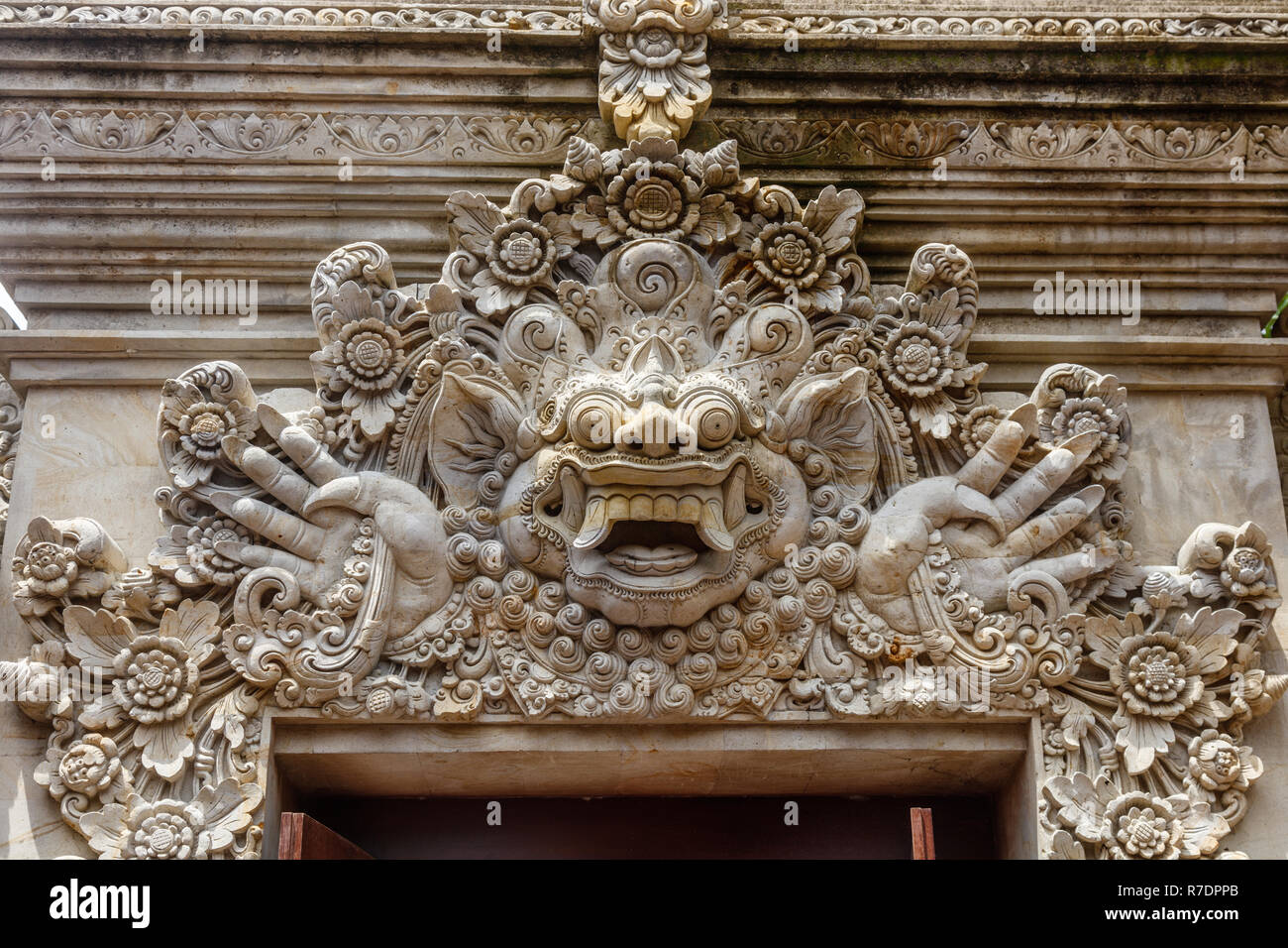 Stone carved Demon Kala in temple entrance decoration, Balinese Hindu ...