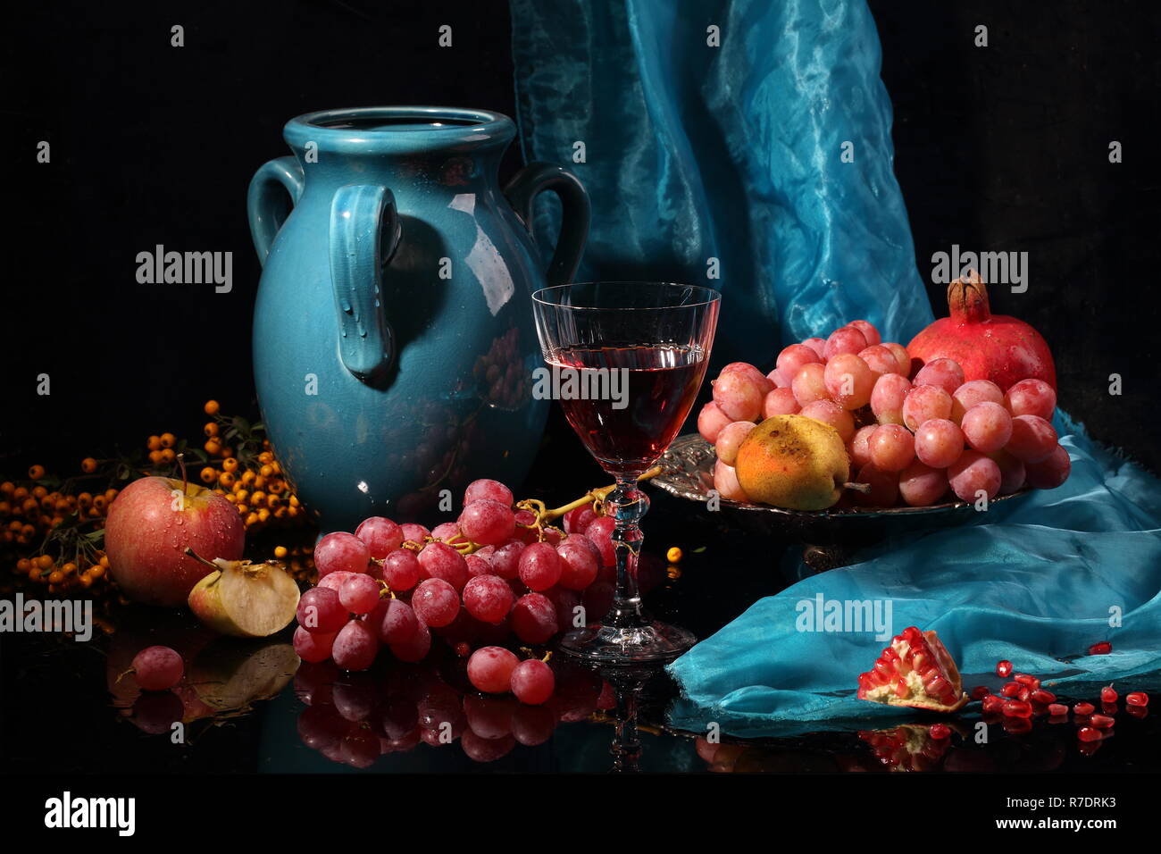 Still life with wine, fruit and dark blue jug Stock Photo - Alamy