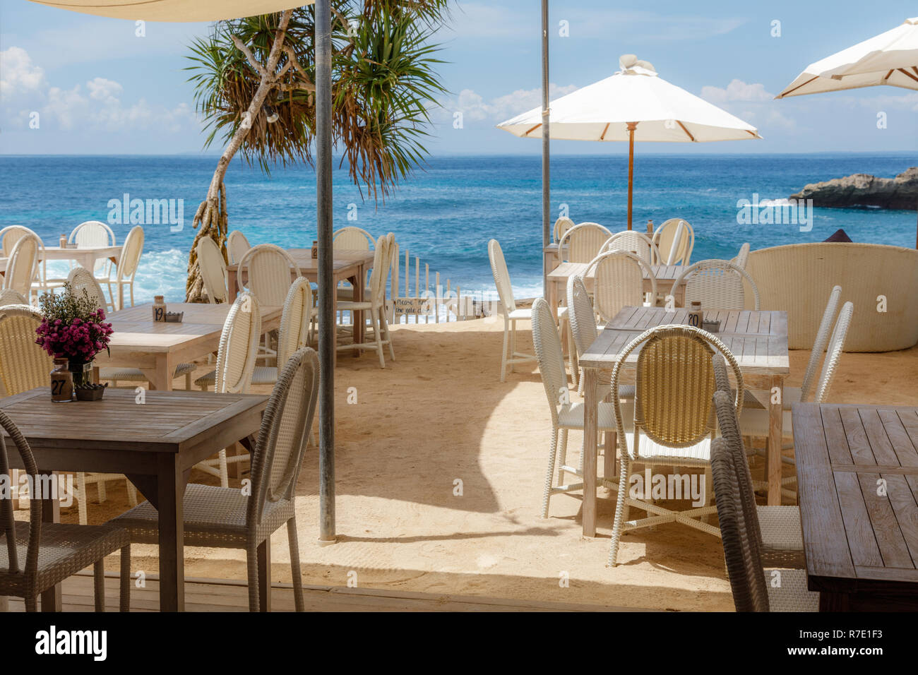 Beach cafe facing the ocean with tables on the sand, Nusa Lembongan ...