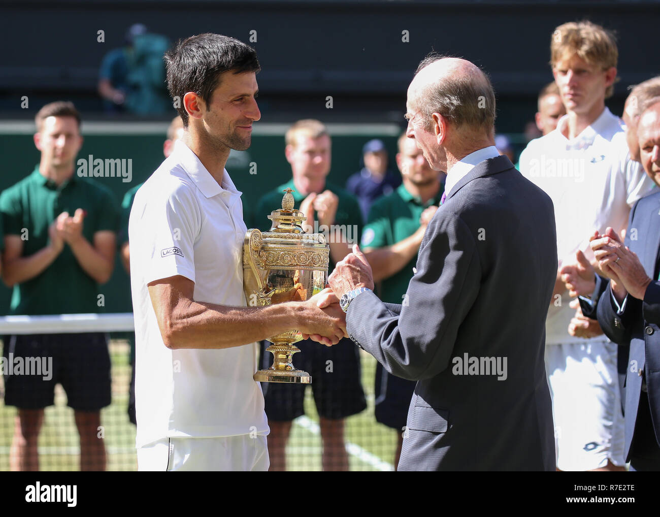 Standing holding receiving achievement smiling professional ...