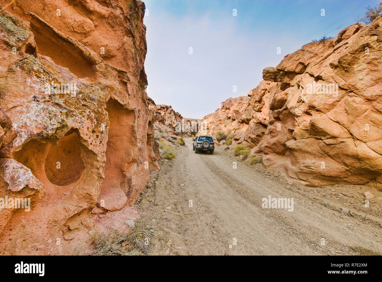 Wind-carved holes in rocks, road at Red Rock Canyon, Mojave Desert ...