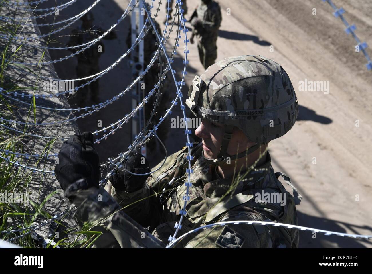 U.S. Army Soldiers with the 19th Engineer Battalion fix concertina wire ...