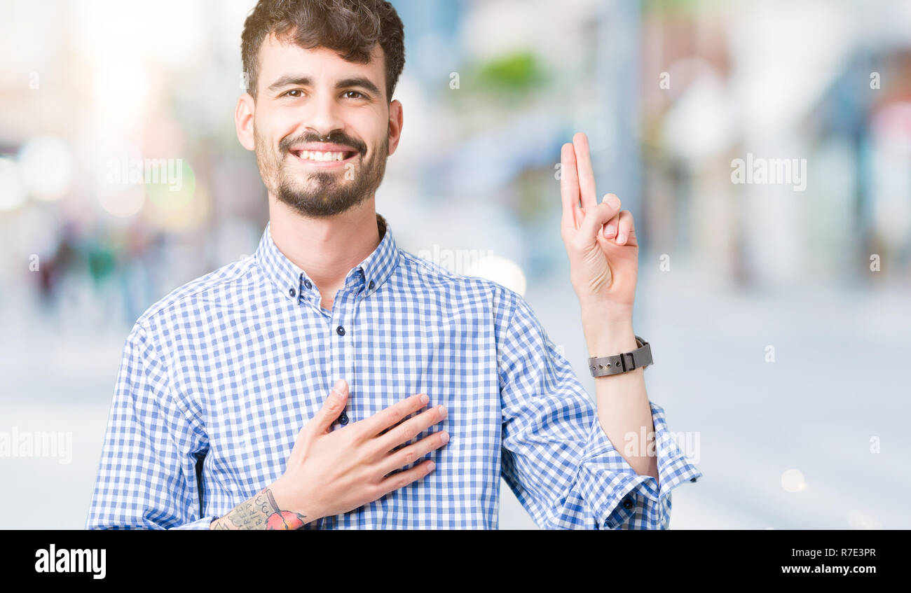 Young handsome business man over isolated background Swearing with hand ...