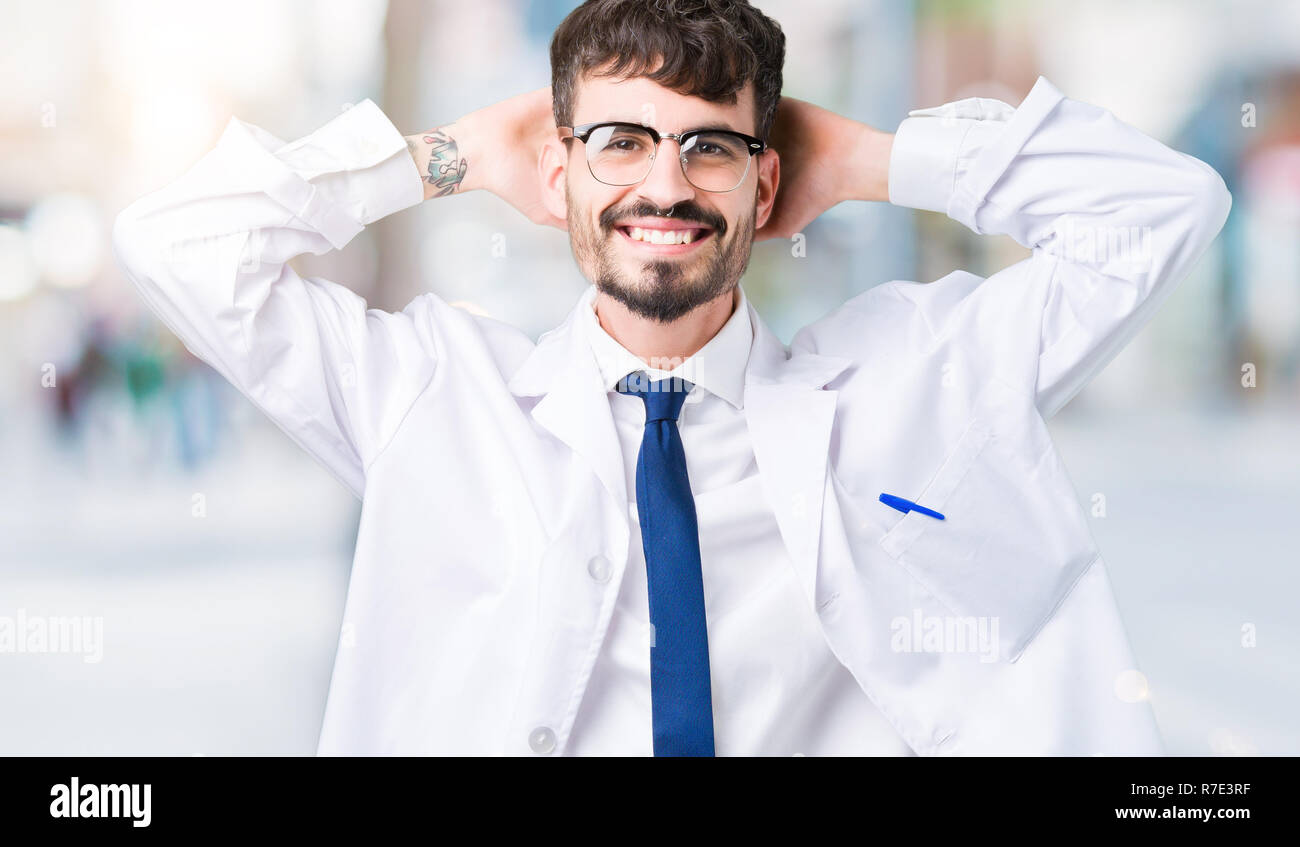 Young professional scientist man wearing white coat over isolated ...