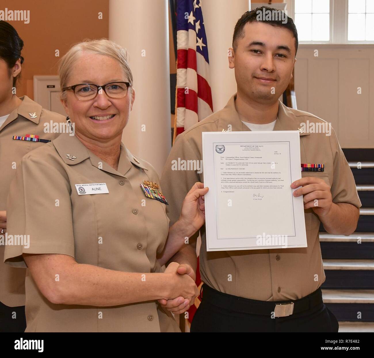 Capt. Dixie Aune presents HM3 Johah Delgadoramirez with his frocking ...