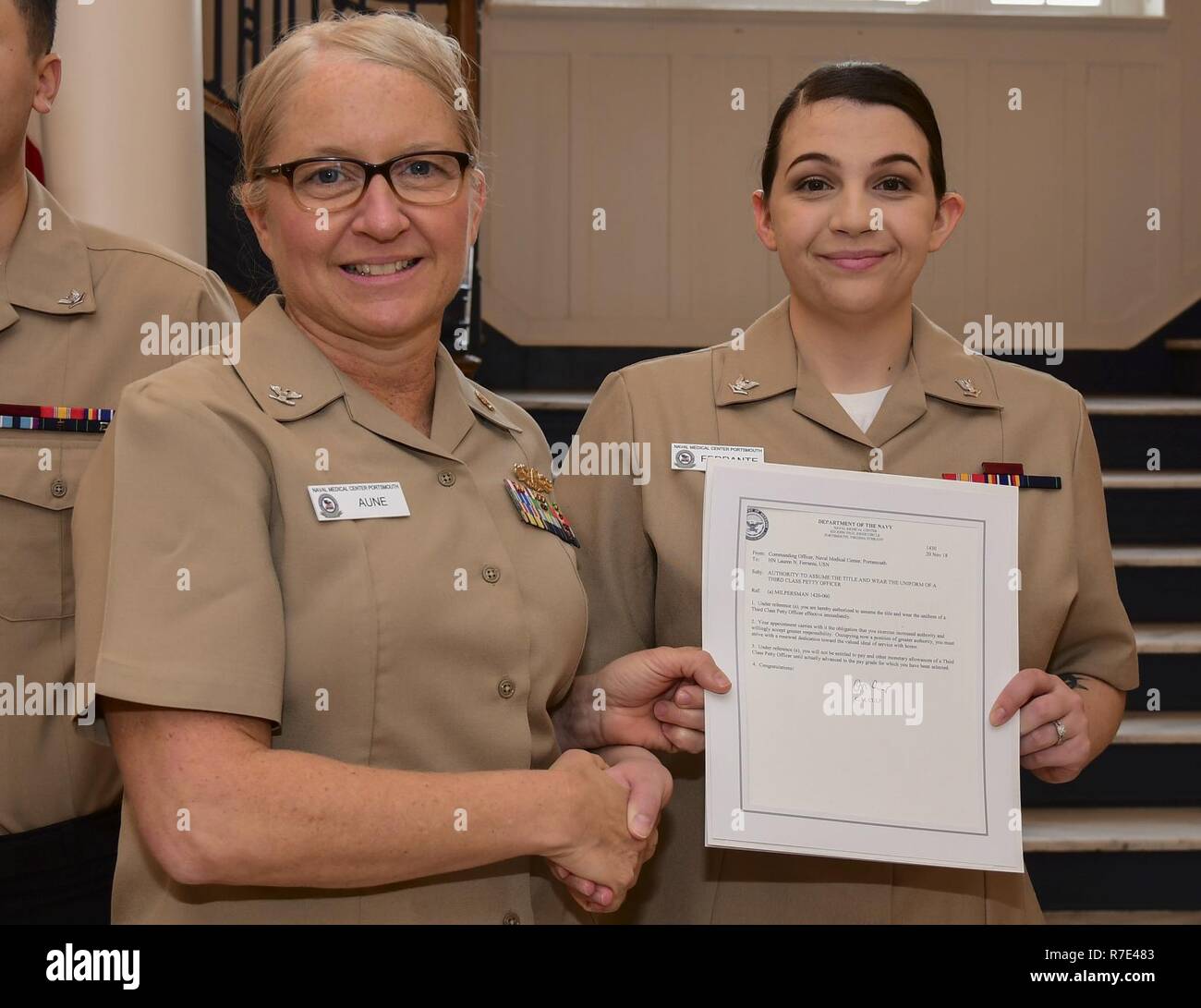 Capt. Dixie Aune presents HM3 Lauren Ferrante with her frocking letter Stock Photo - Alamy
