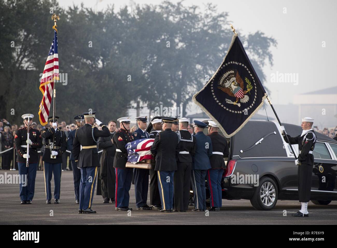 U.S. service members with the Joint Forces Honor Guard place the casket of former U.S. President ...