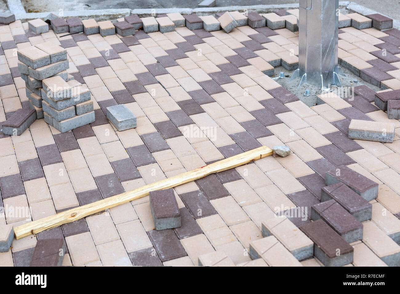 New stainless electric pole installation. Concrete stone paving flag ...