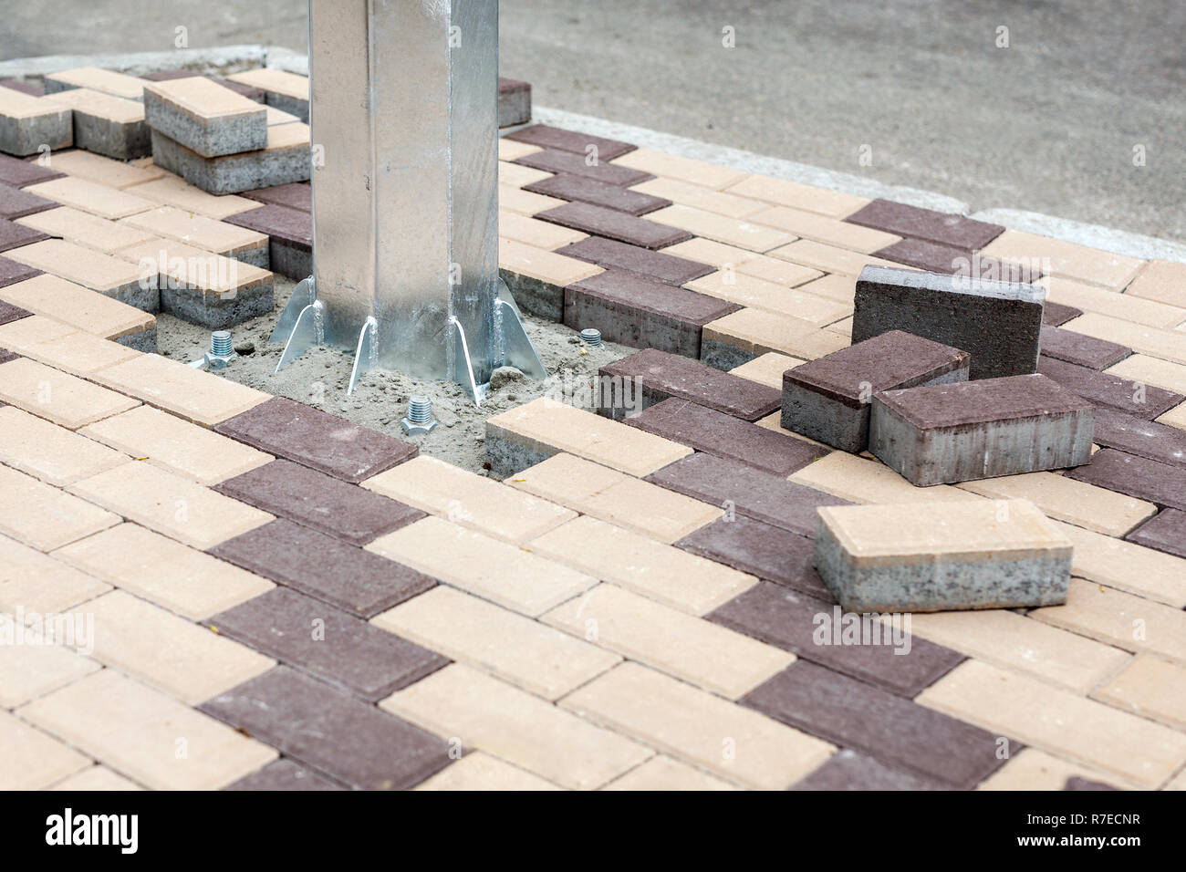 New stainless electric pole installation. Concrete stone paving flag ...