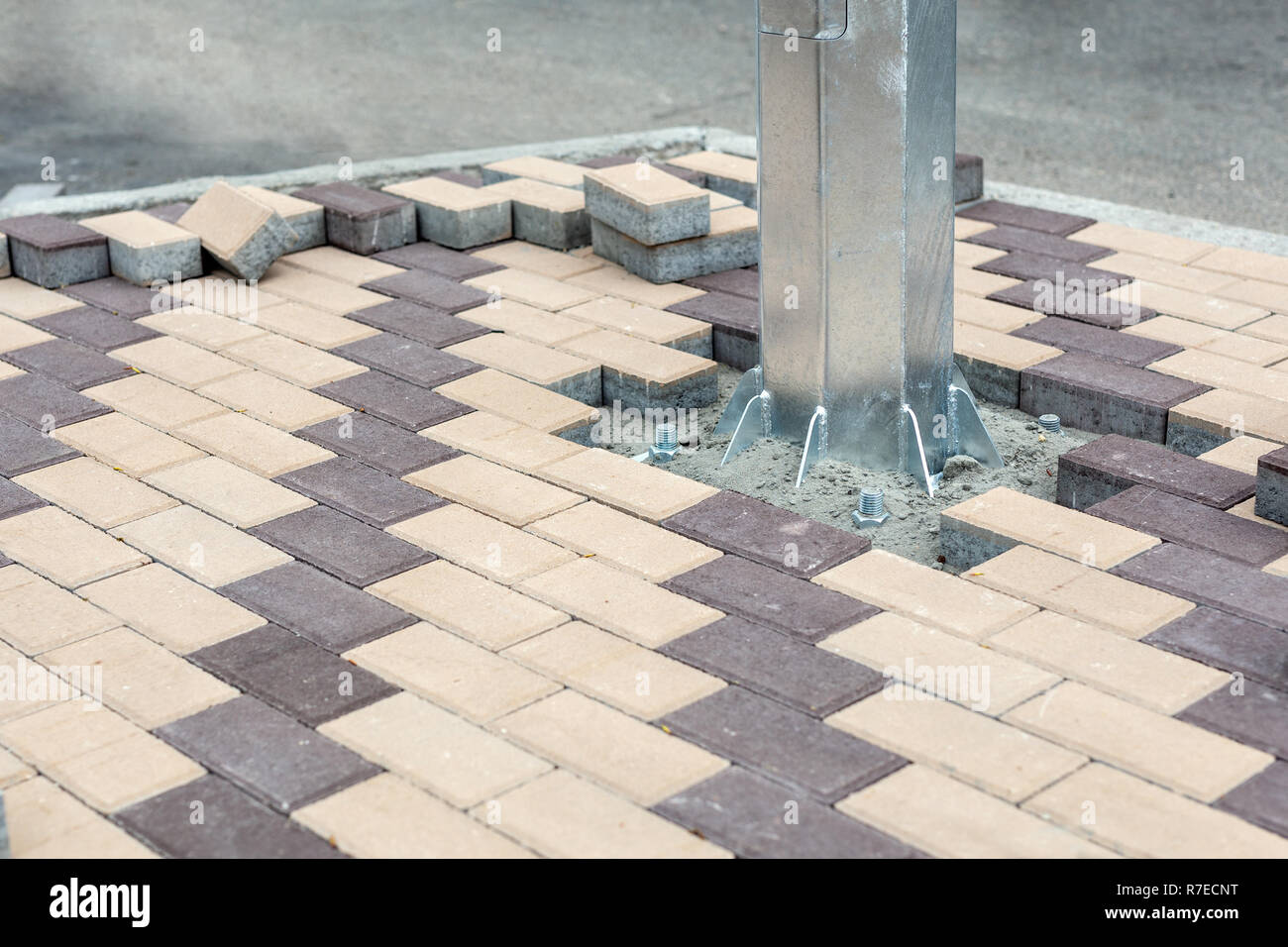 New stainless electric pole installation. Concrete stone paving flag ...