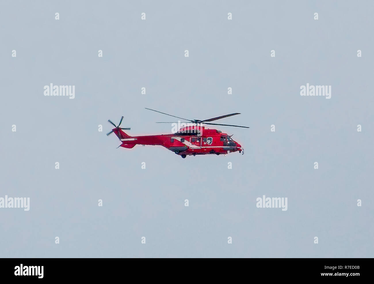 Red rescue helicopter flying on clear sky Stock Photo - Alamy