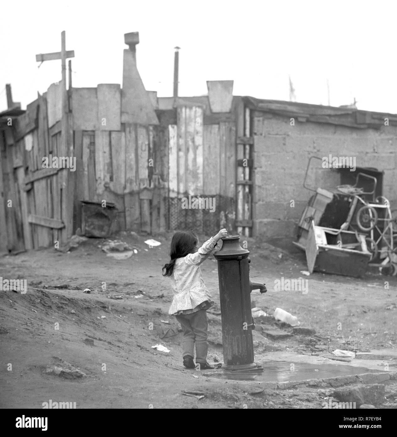 A child plays with a hydrant in a slum near Paris, France, in November ...