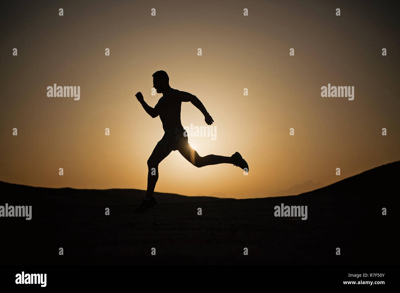man running silhouette on sunset background, young caucasian run in ...