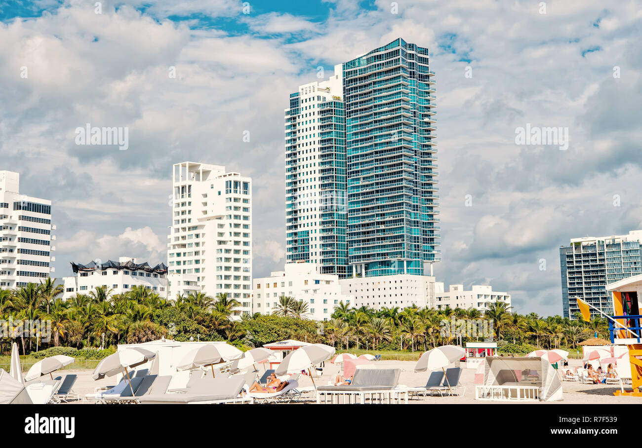Miami, USA - January 10, 2016: beach with deck chairs under grey ...