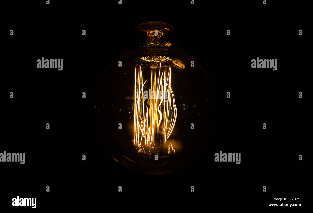 Large long electric incandescent filament in a retro style light bulb ...