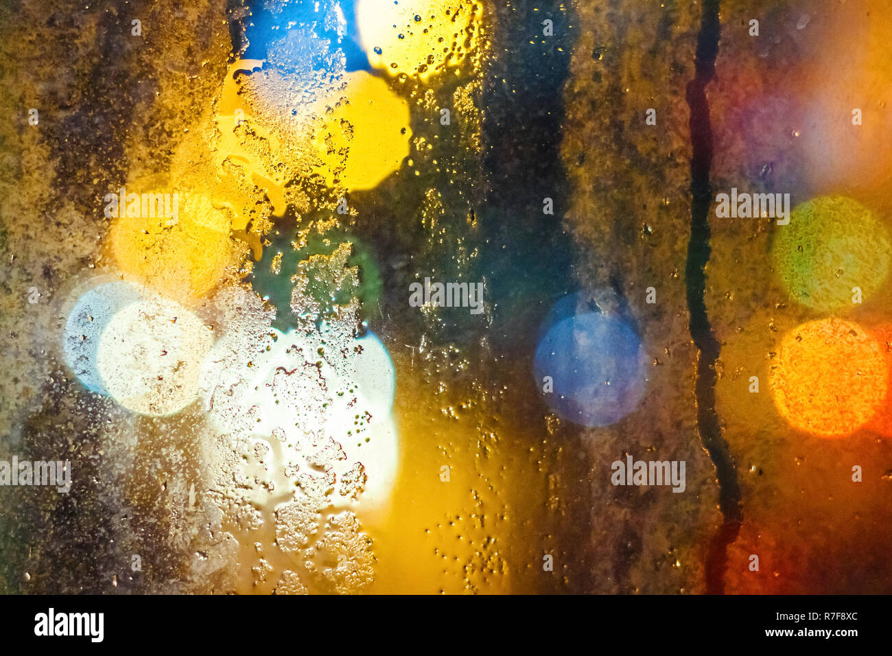 Rain drops on window with blurry background Stock Photo - Alamy