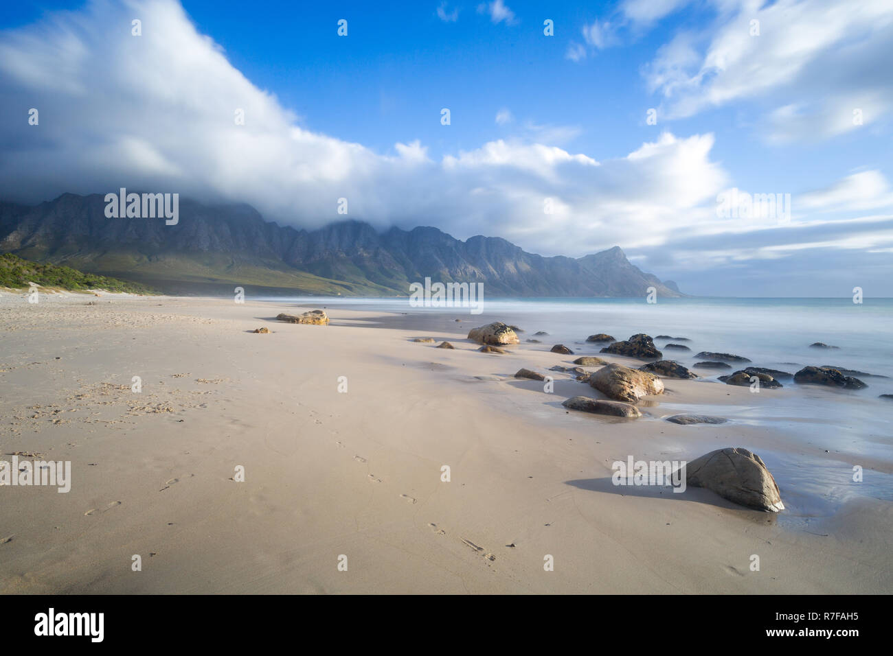 Clouds over the mountains at the beach Stock Photo - Alamy