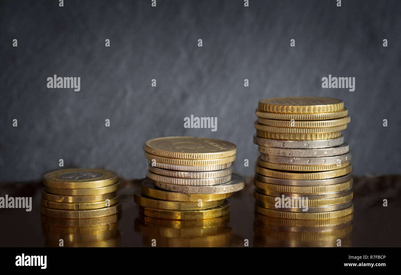 coin columns on dark background Stock Photo - Alamy