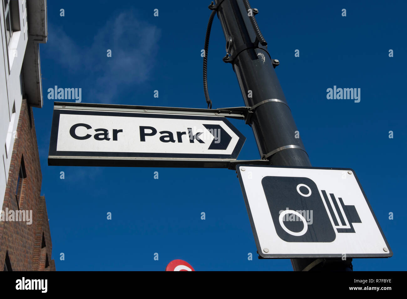 british road signs indicating a car park to the right and traffic ...