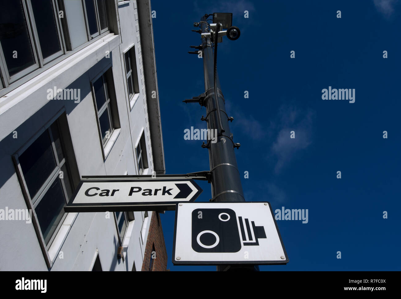 british road signs indicating a car park to the right and traffic ...