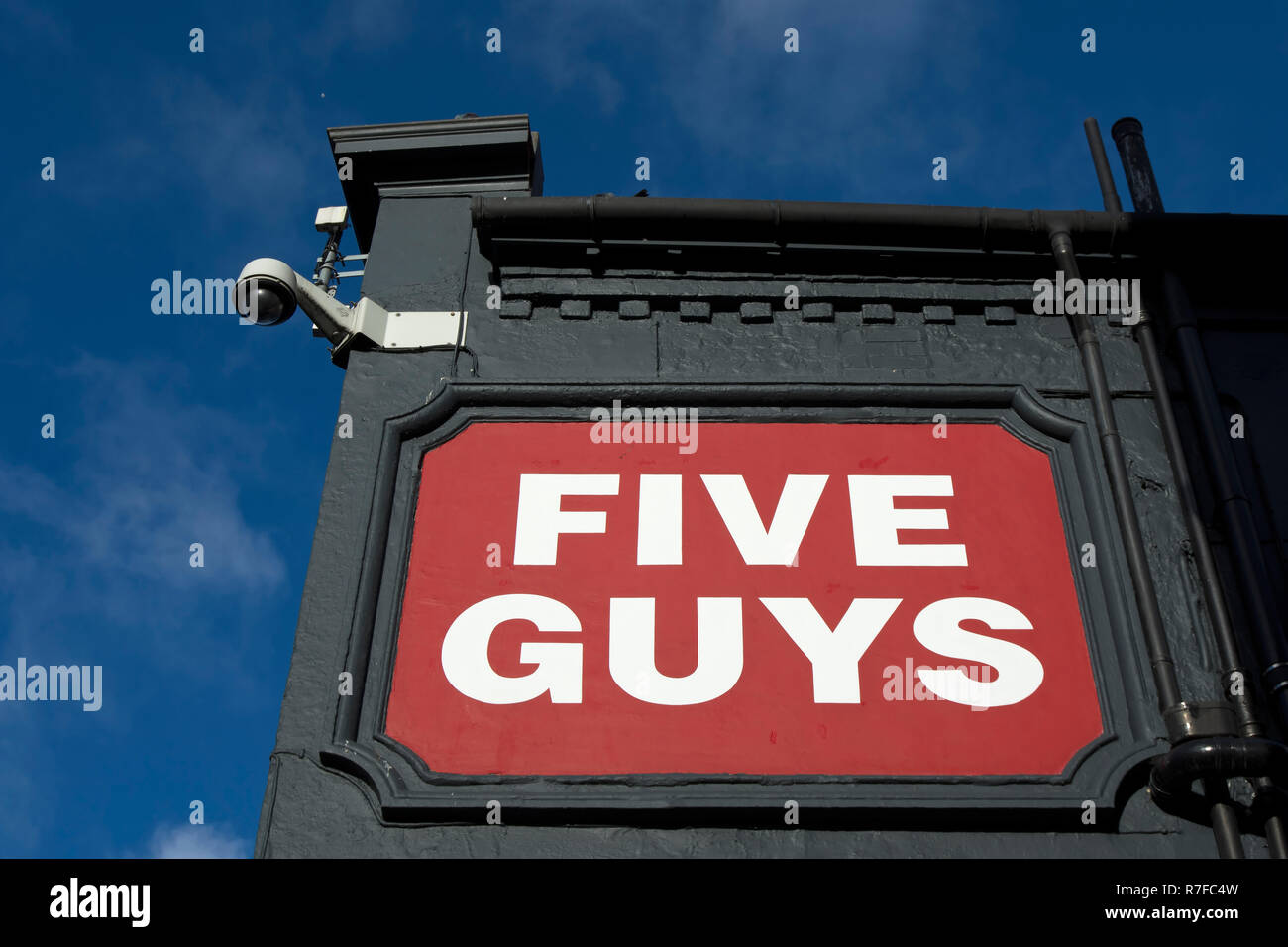 name sign at a branch of the burger restaurant chain five guys, in ...