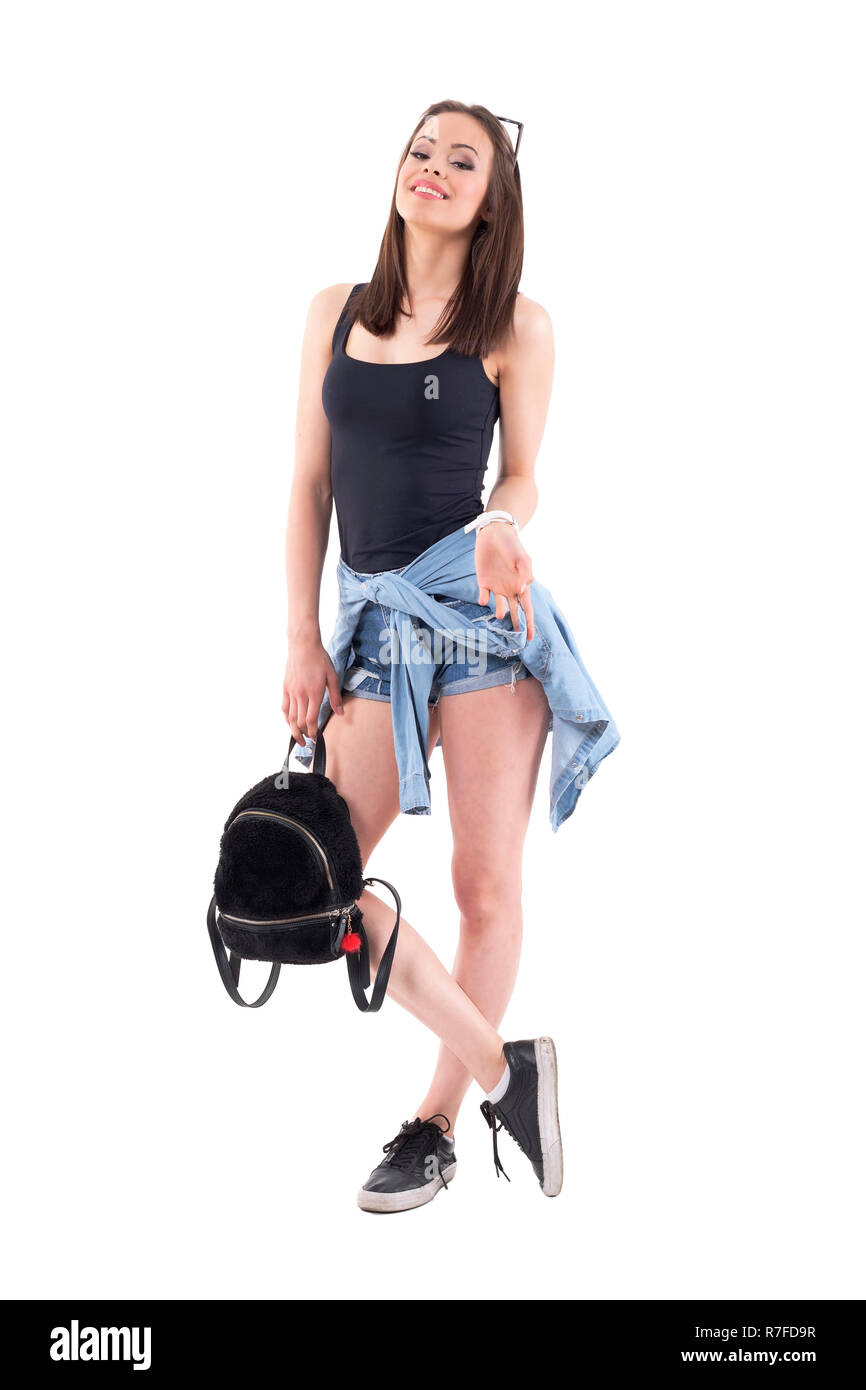 Confident happy young woman fashion model posing and smiling with bag ...